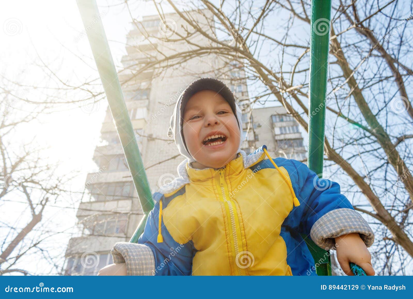 A Cute Boy is Riding a Swing in the Playground Stock Image - Image of ...