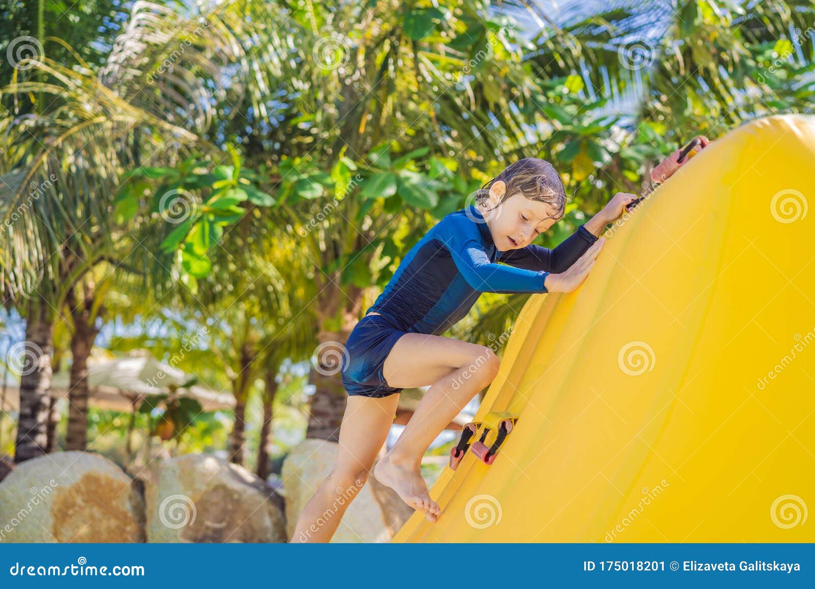 Cute Boy Runs an Inflatable Obstacle Course in the Pool Stock Image ...