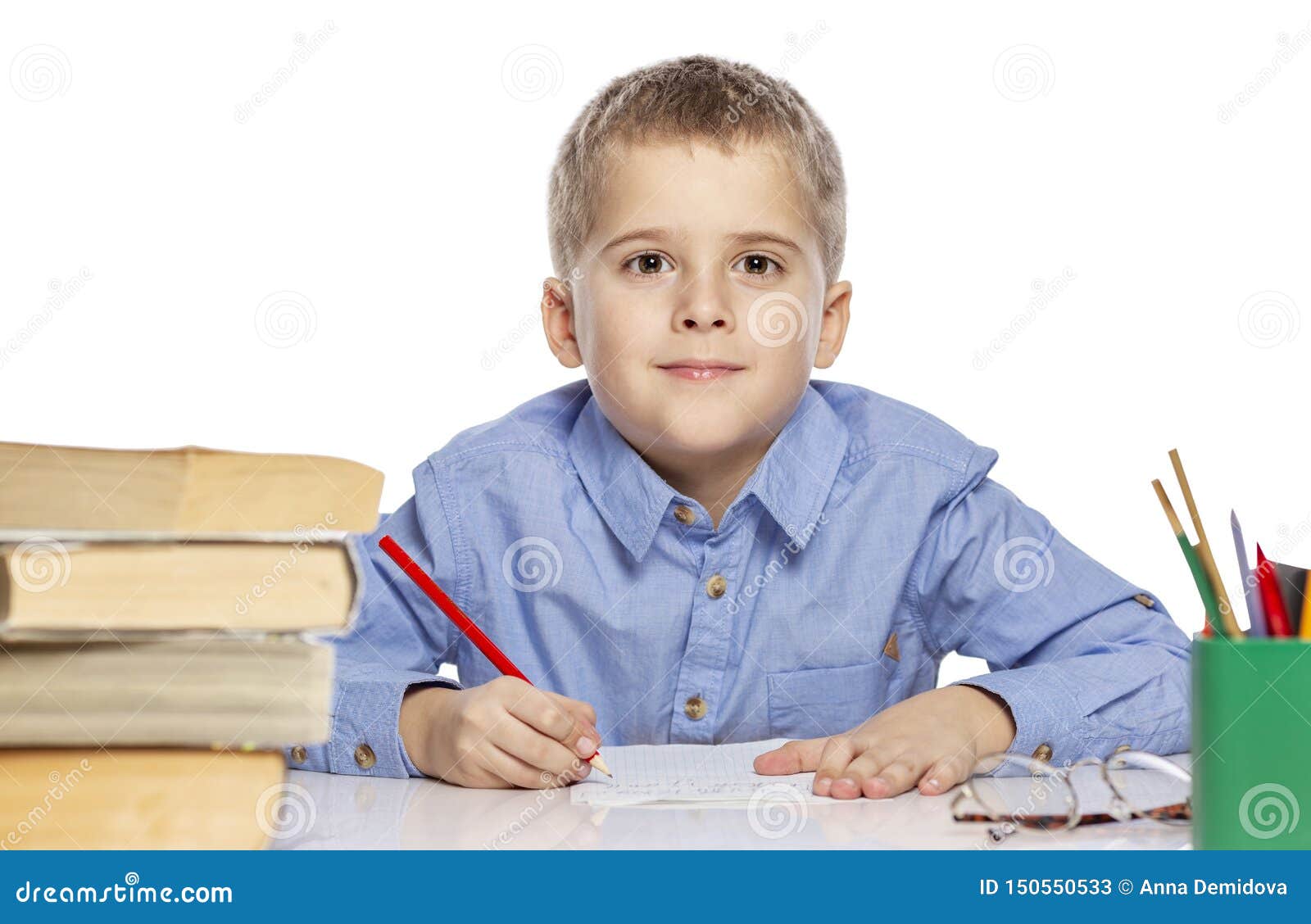 Cute Boy of School Age Doing Homework at the Table. it is Interesting ...