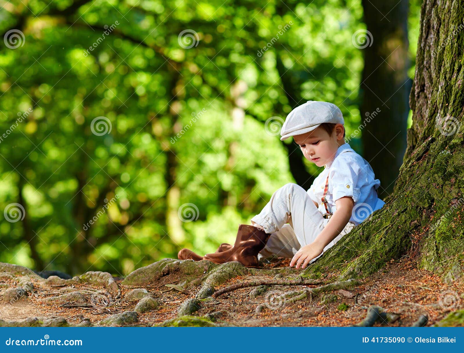 Cute Boy Sitting Under An Old Tree, In The Forest Stock Photo - Image ... Cute Boy Sitting Under An Old Tree, In The Forest Stock Photo - Image ...