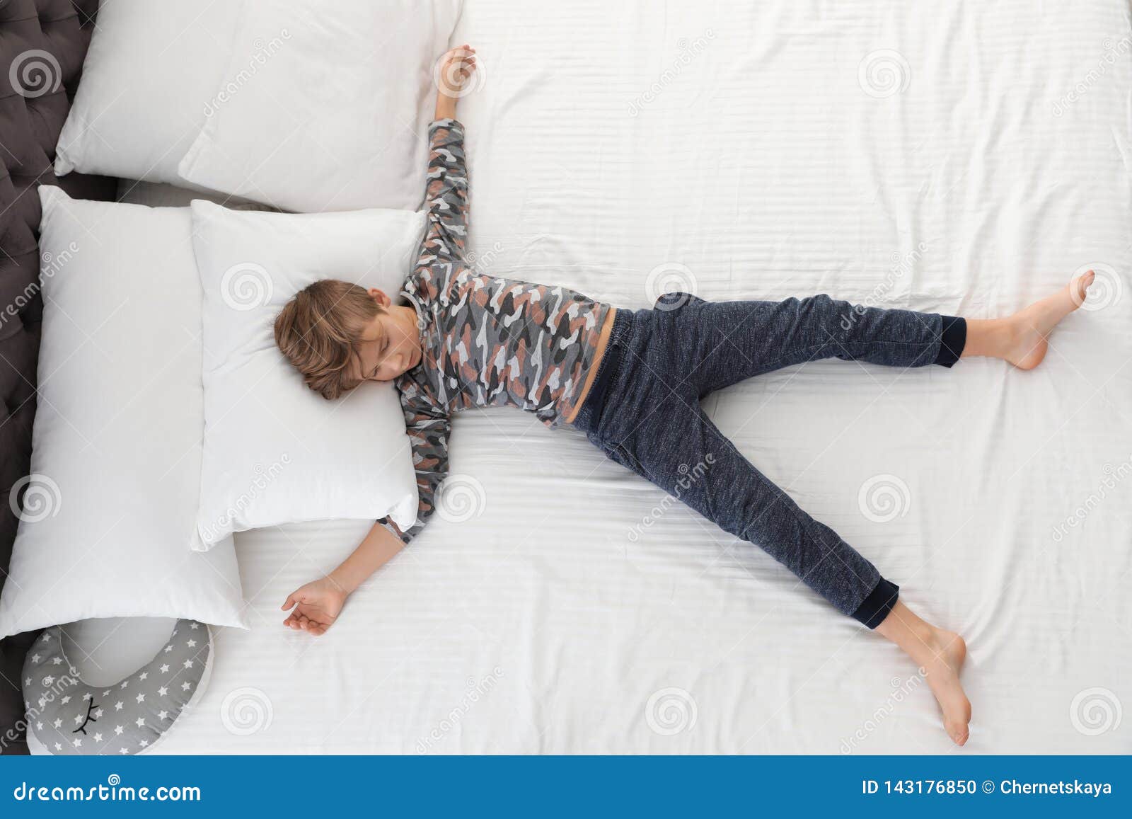 Cute boy sleeping on bed stock photo. Image of pajama - 143176850