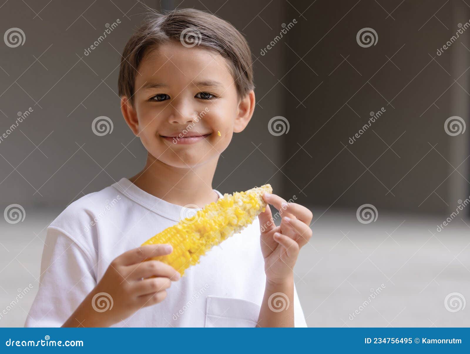 A Cute Boy Smiling and Holding Corn on the Cob Stock Image - Image of ...