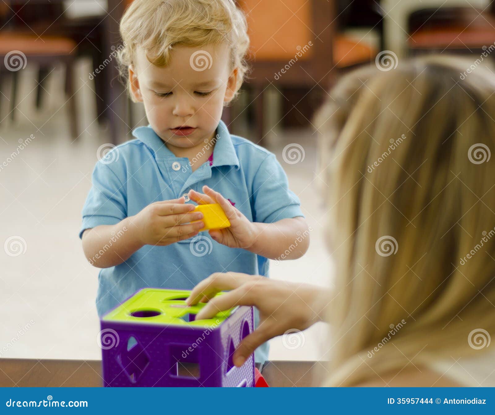 Cute boy solving a puzzle stock photo. Image of young - 35957444