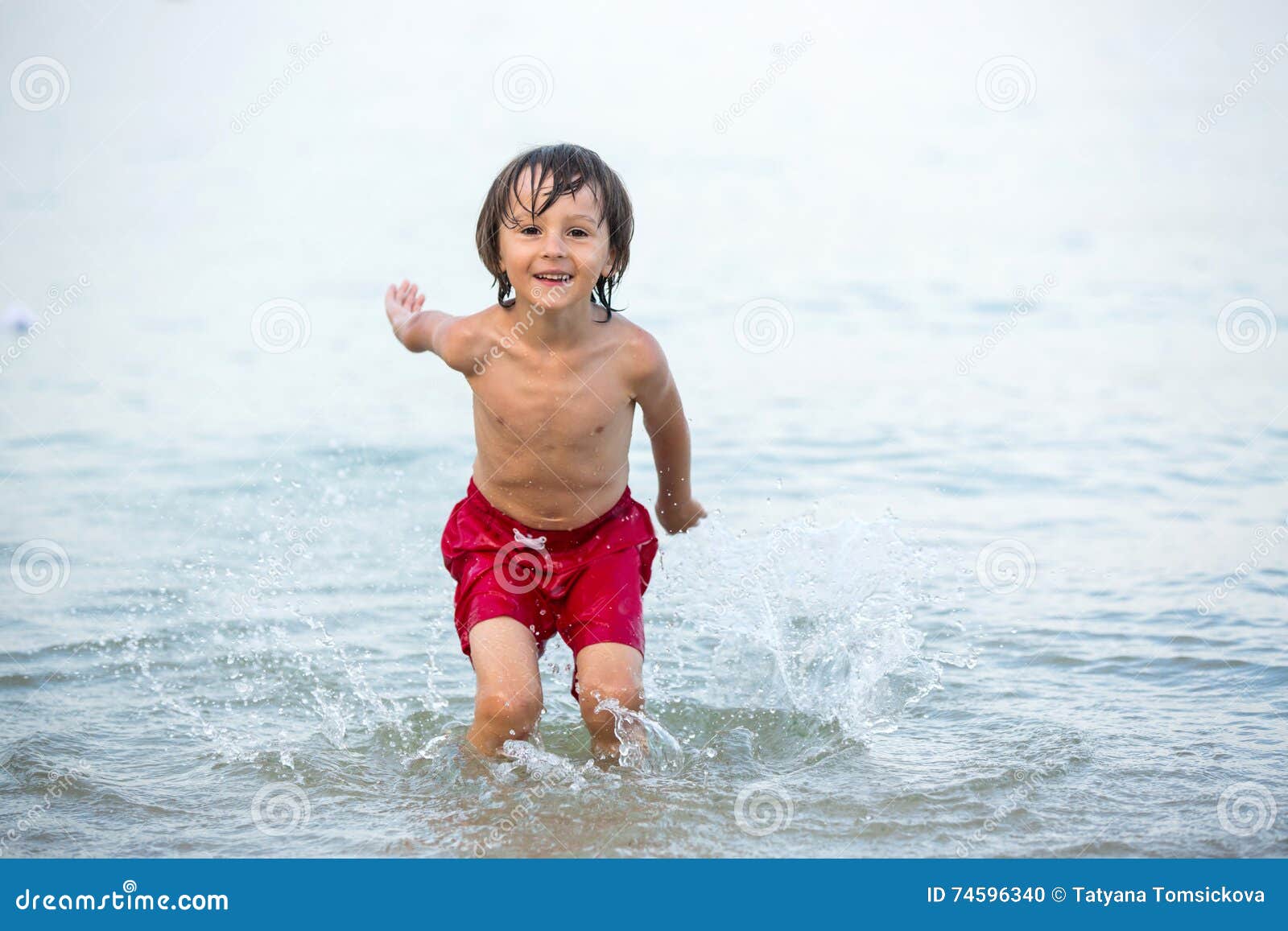 Cute Boy, Splashing Water on the Beach Stock Photo - Image of ...