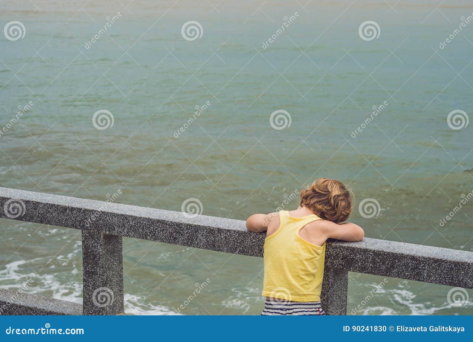 Cute Boy Stands on the Shore Watching the Ocean Waves Stock Photo ...