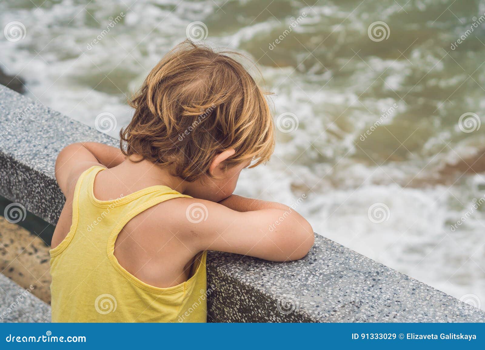 Cute Boy Stands on the Shore Watching the Ocean Waves Stock Image ...