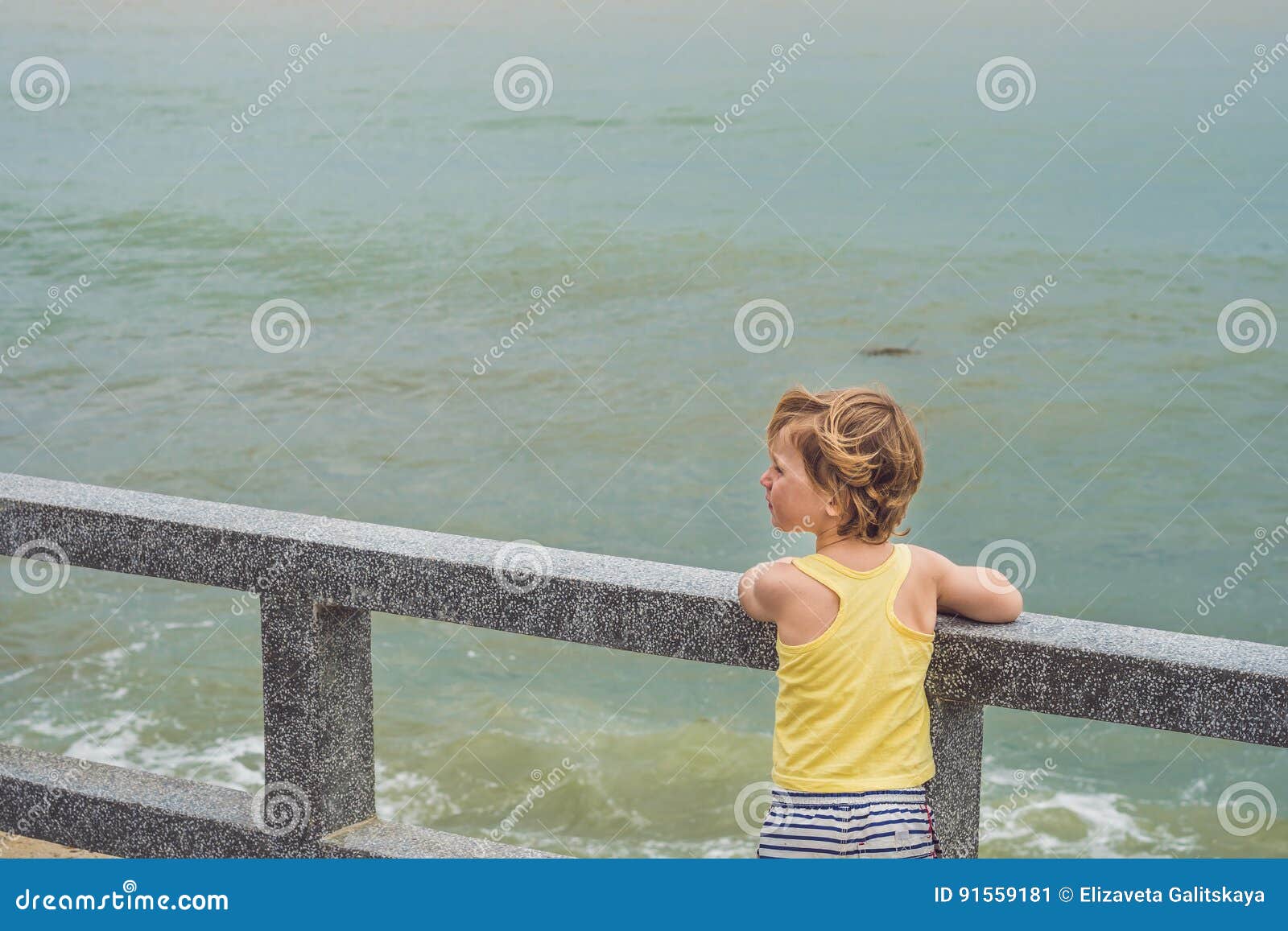 Cute Boy Stands on the Shore Watching the Ocean Waves Stock Image ...
