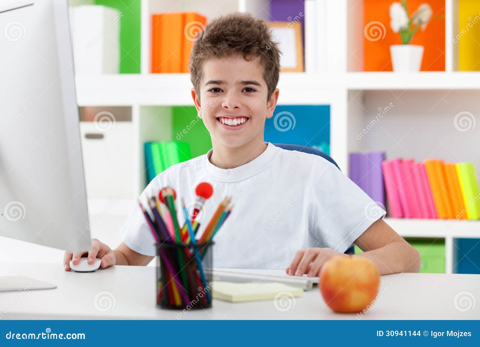 Cute Boy Using a Computer and Smiling Stock Photo - Image of education ...