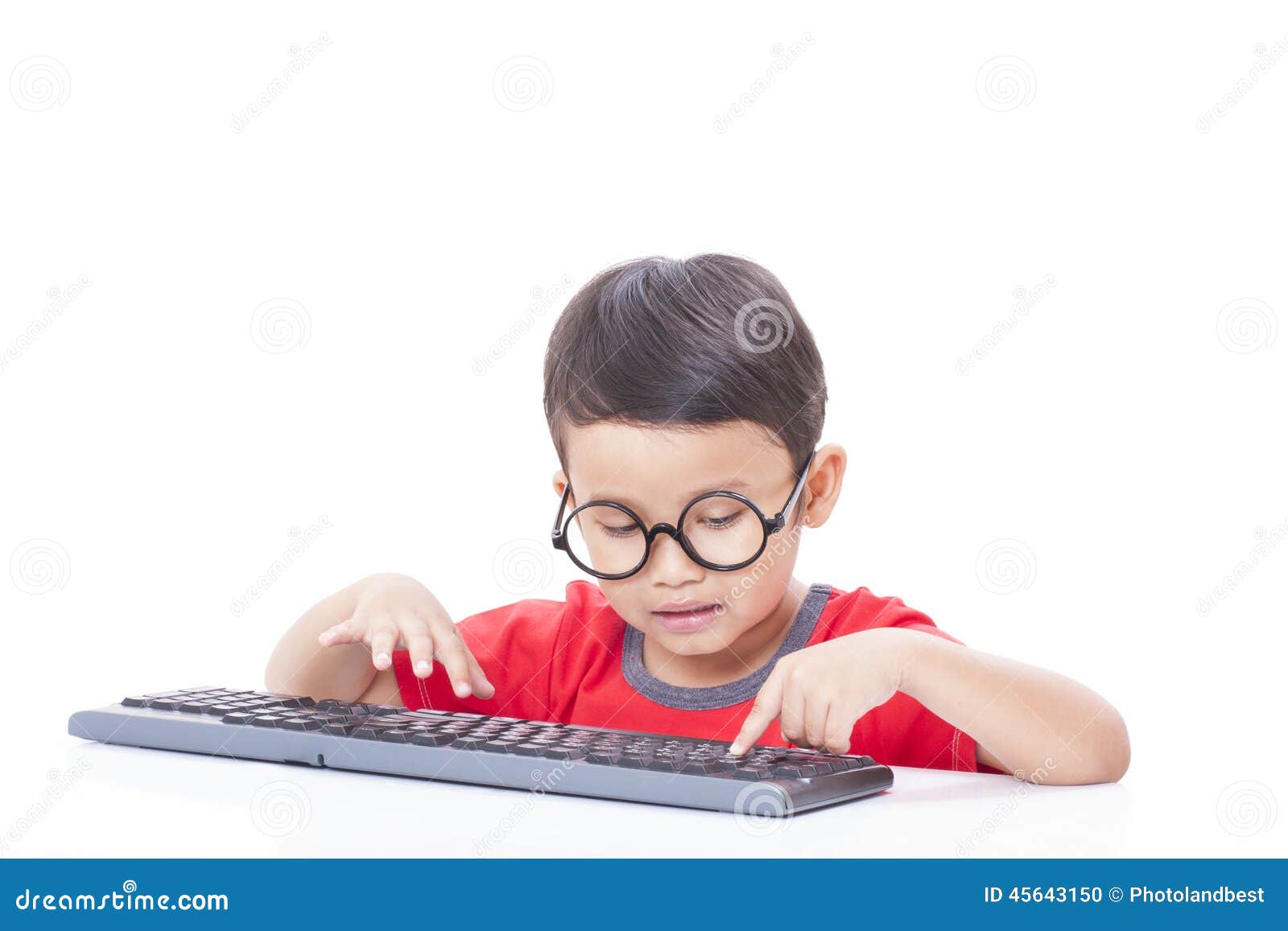 Cute Boy using a keyboard stock photo. Image of fingers - 45643150