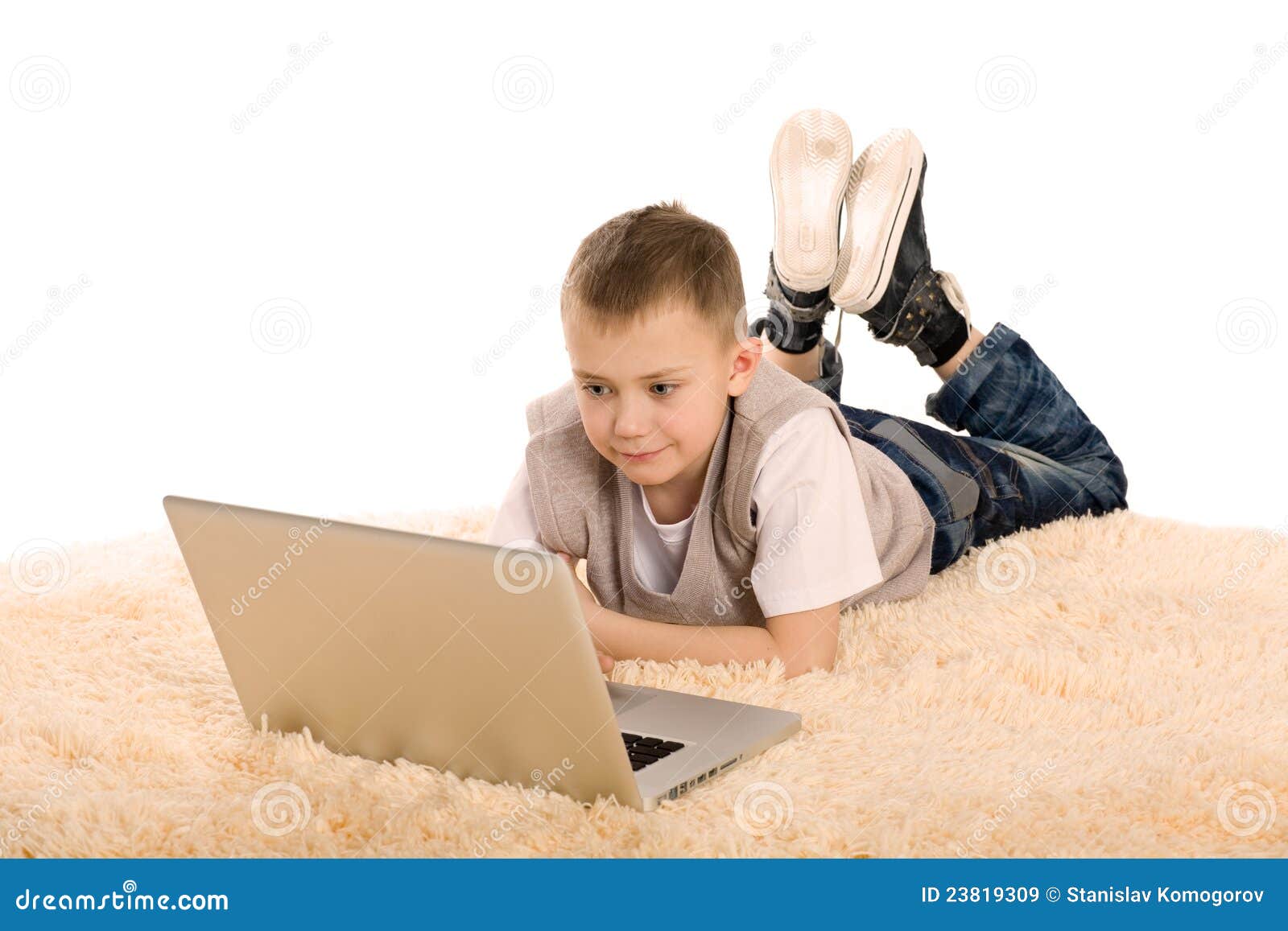 Cute boy using a laptop stock image. Image of learn, lying - 23819309