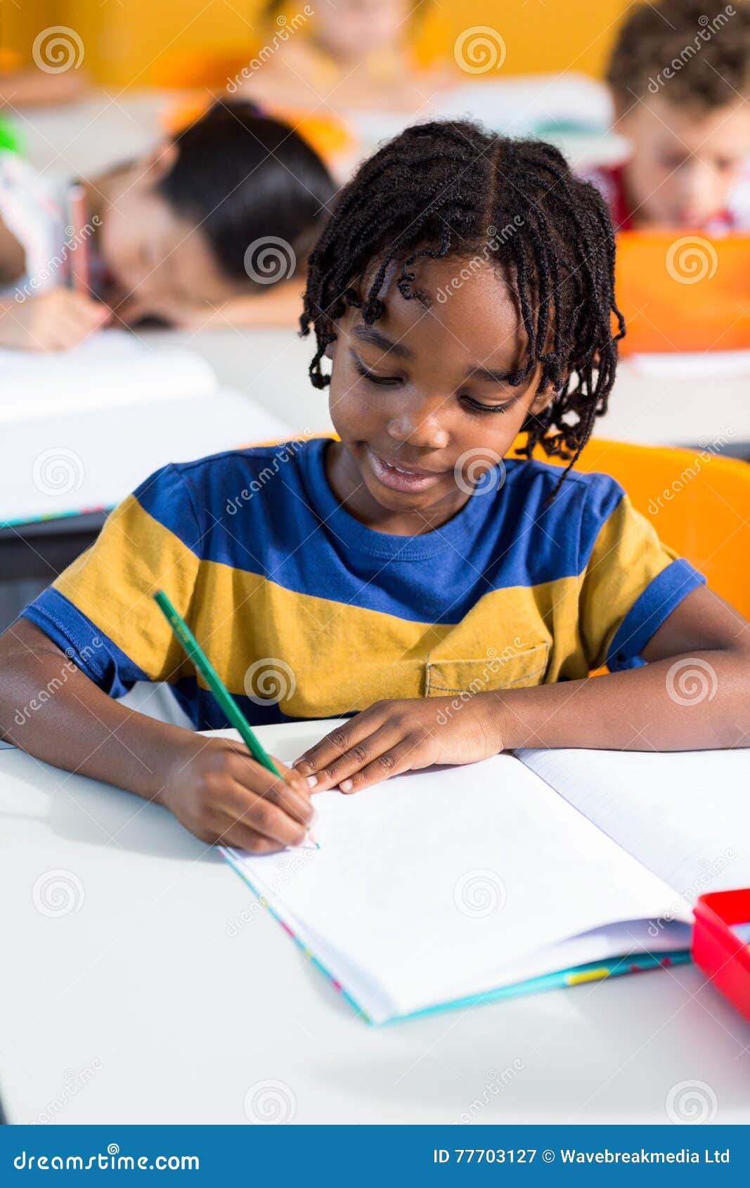 Cute boy writing on book stock image. Image of focus - 77703127