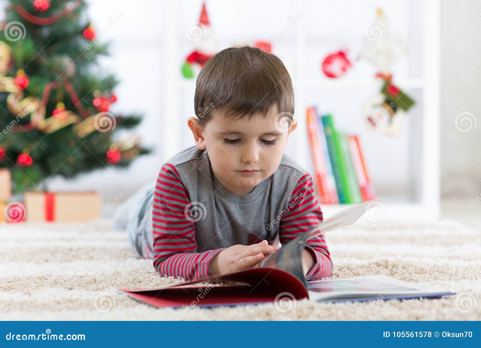 Cute Child Boy Reading a Book in Front of the Christmas Tree, Christmas ...