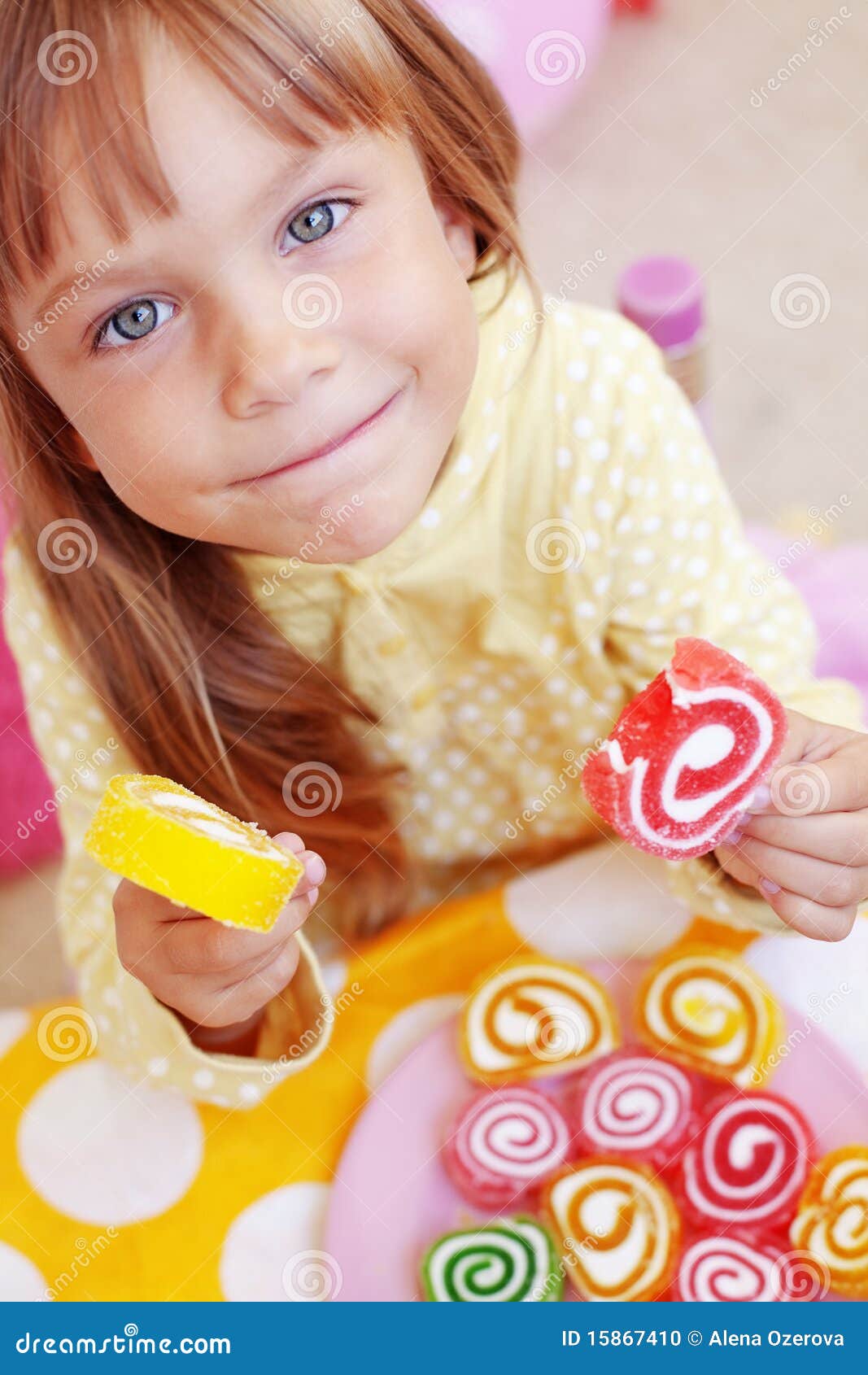Cute child eating candies stock photo. Image of holding - 15867410
