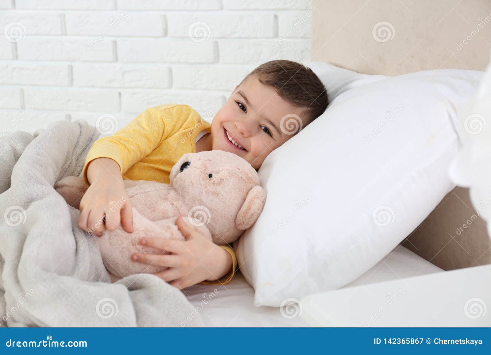 Cute child resting in bed stock image. Image of patient - 142365867
