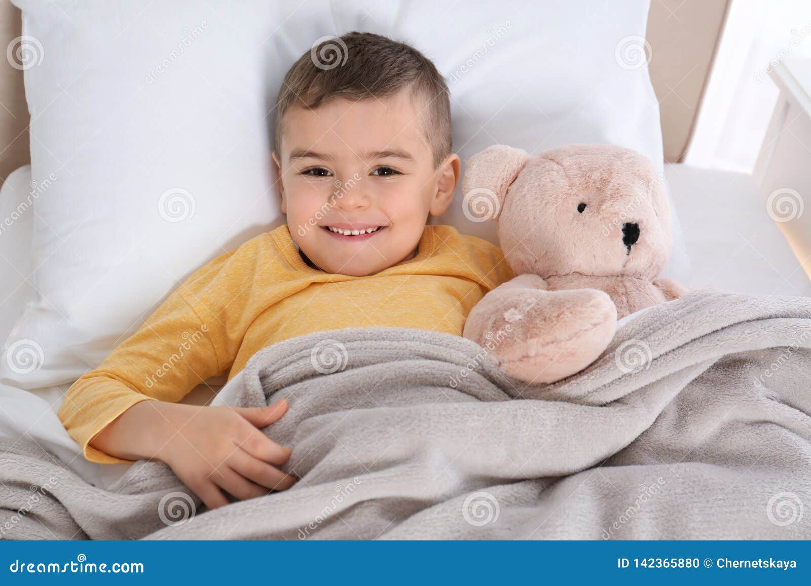 Cute child resting in bed stock photo. Image of child - 142365880