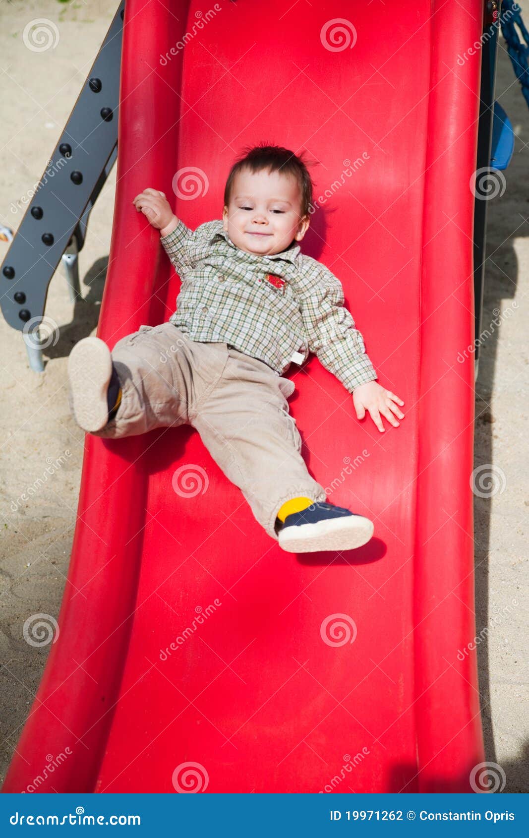 Cute child on slide stock photo. Image of enjoying, outdoors - 19971262