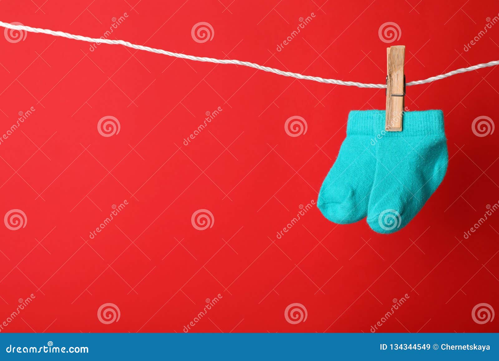 Cute Child Socks on Laundry Line Against Color Background Stock Image ...