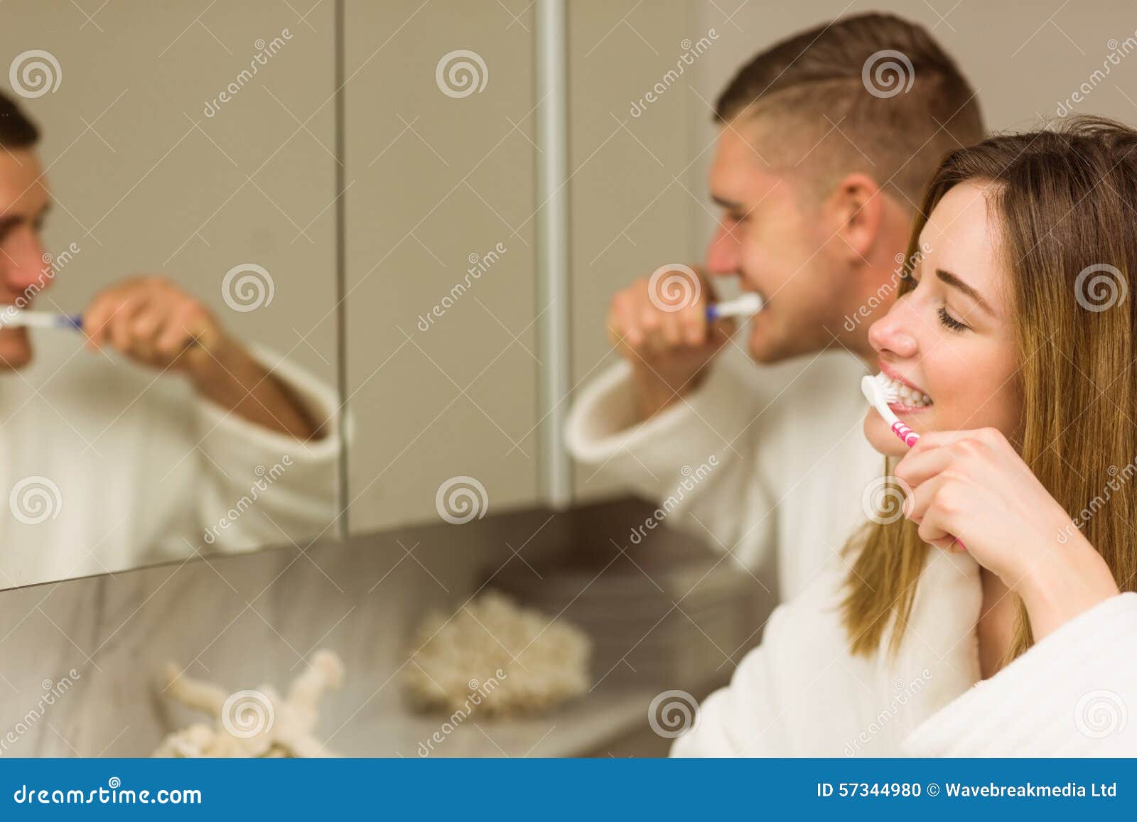 Cute Couple Brushing Their Teeth Stock Photo - Image of dressing, focus ...