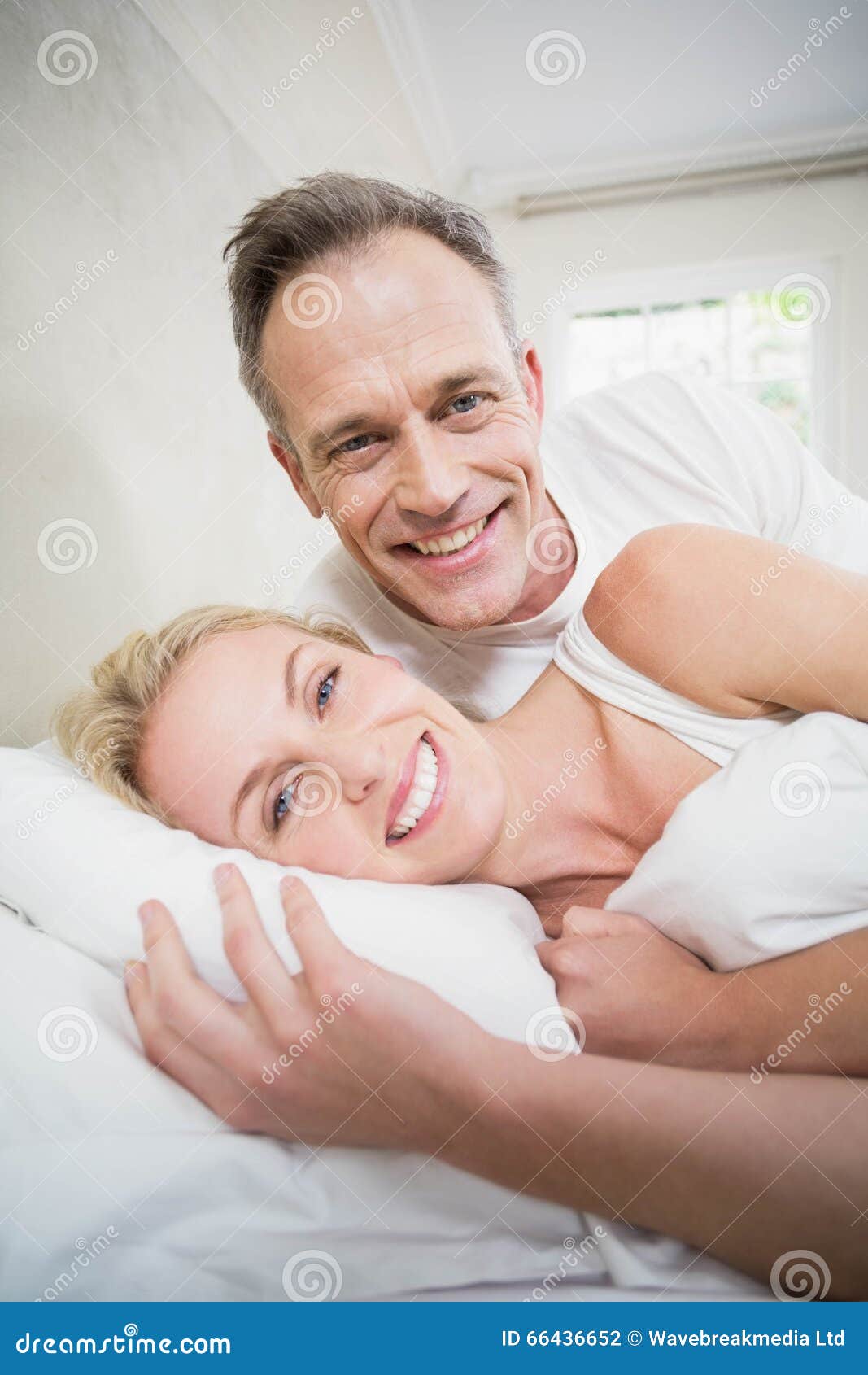 Cute Couple Cuddling in Bed Stock Photo - Image of grey, indoors: 66436652
