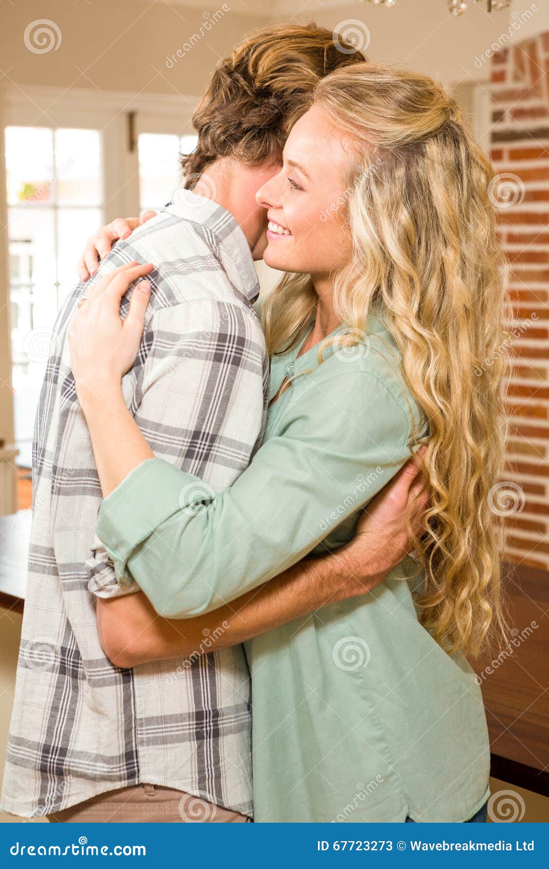 Cute couple cuddling stock image. Image of apartment - 67723273