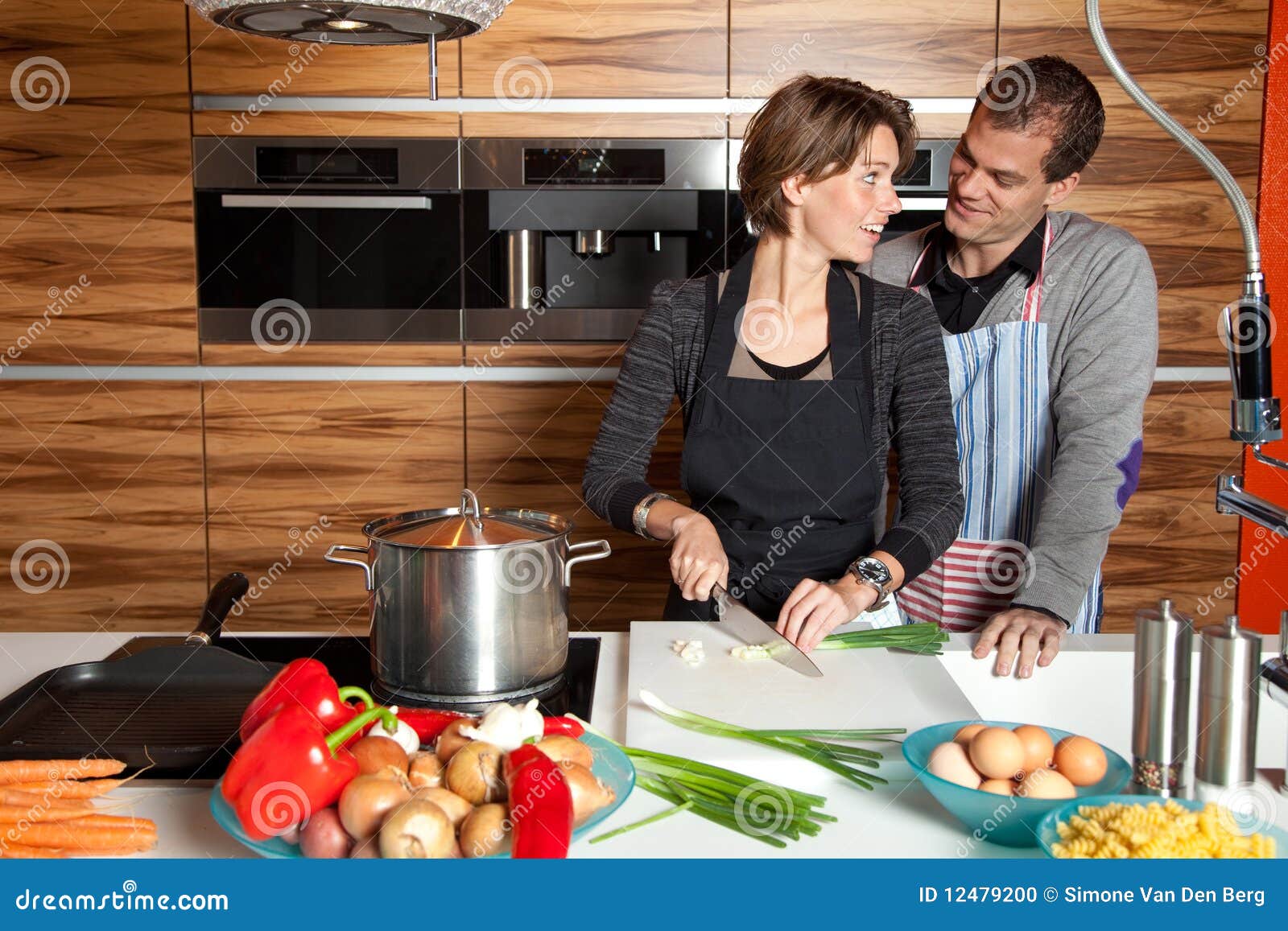 Cute couple in the kitchen stock photo. Image of smiling - 12479200