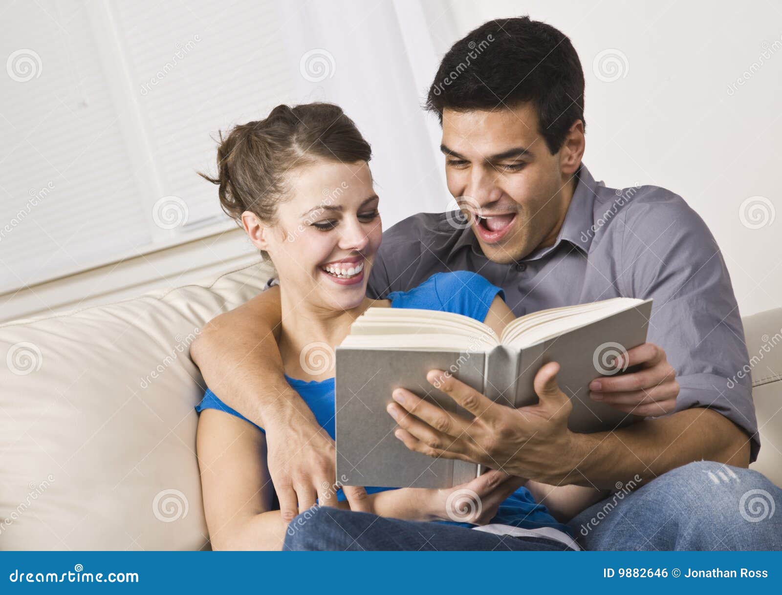 Cute Couple Reading and Laughing Together Stock Photo - Image of ...