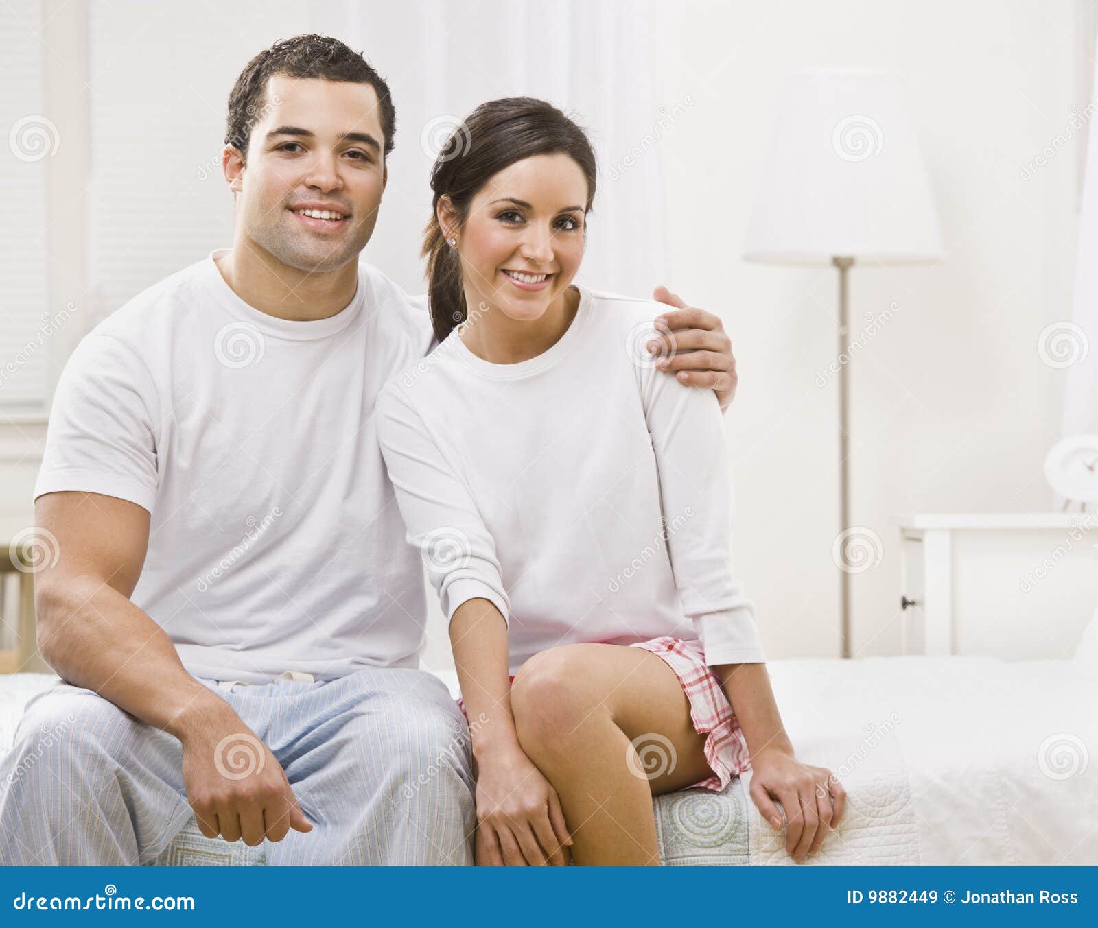 Cute Couple Sitting Together In Their Bedroom Stock Image - Image of ...
