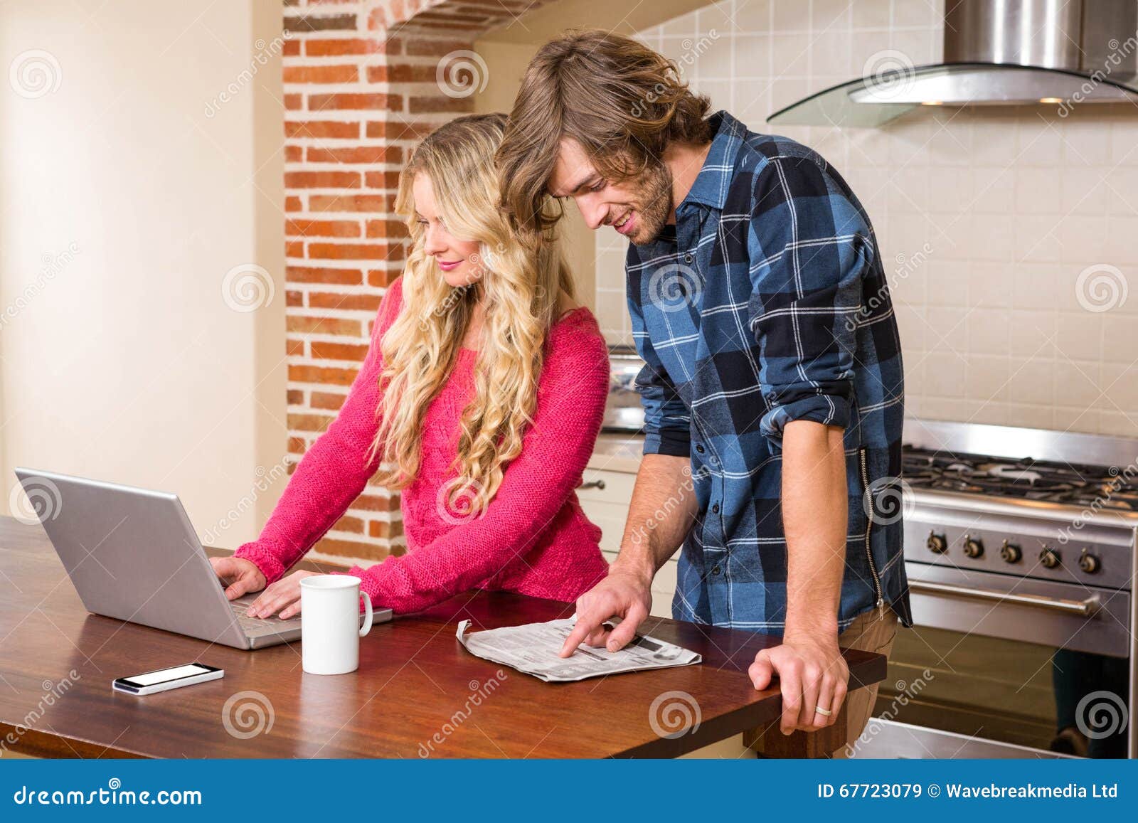 Cute Couple Using Laptop and Reading Newspaper Stock Image - Image of ...