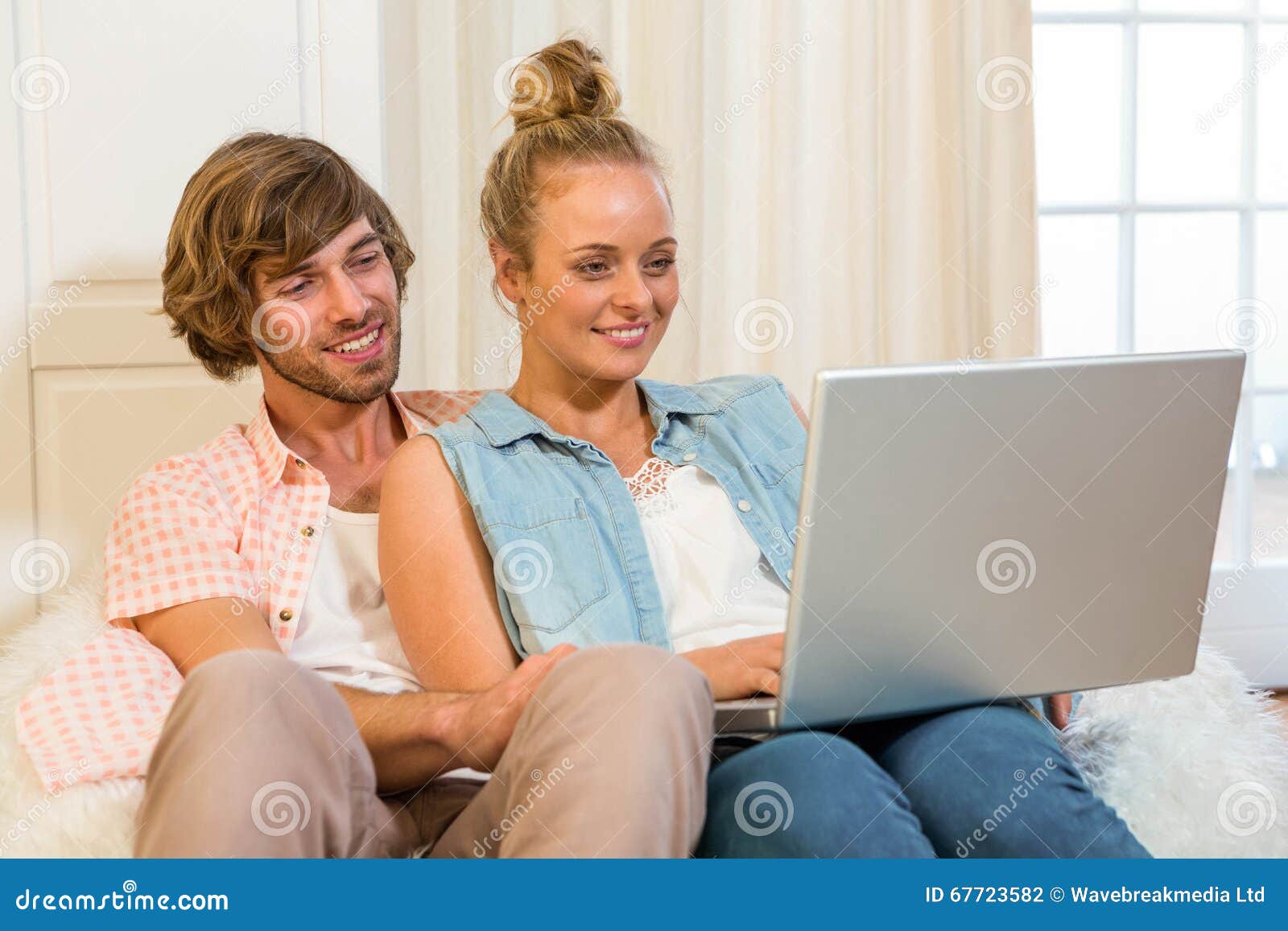 Cute Couple Using Laptop Sitting on the Couch Stock Photo - Image of ...