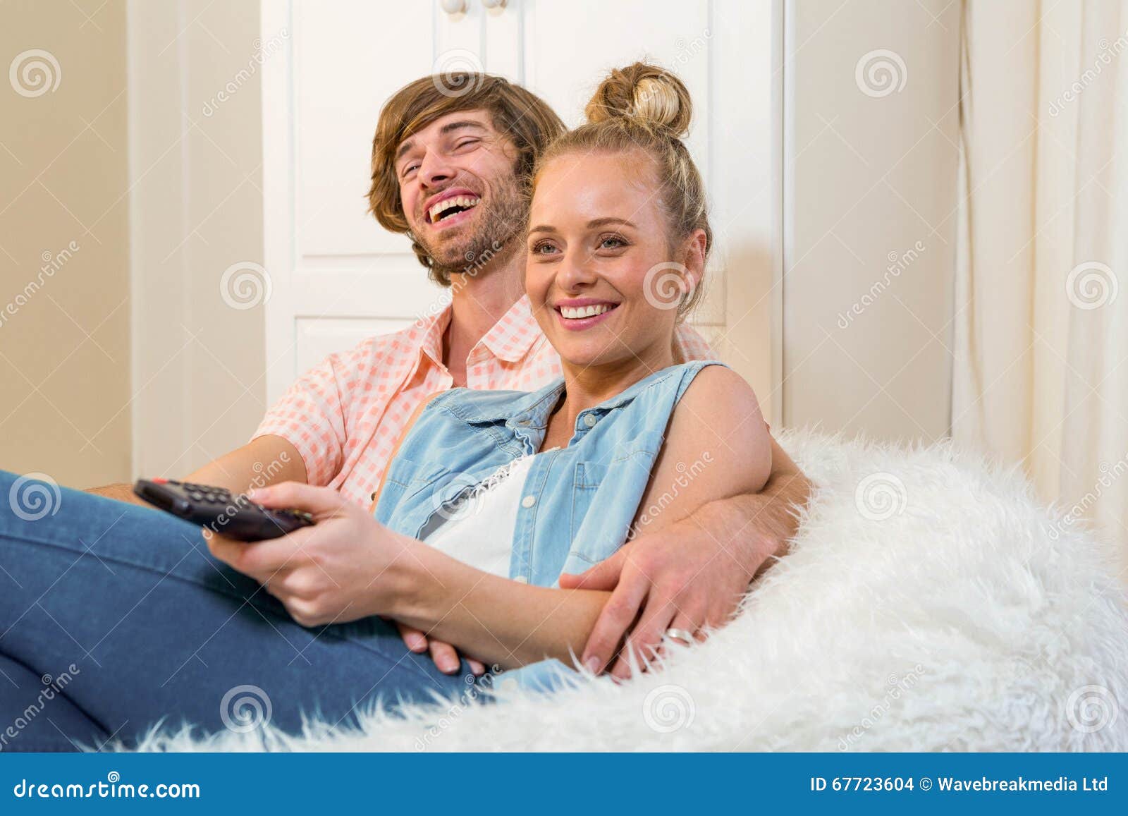 Cute Couple Watching Tv and Using Remote on the Couch Stock Photo ...