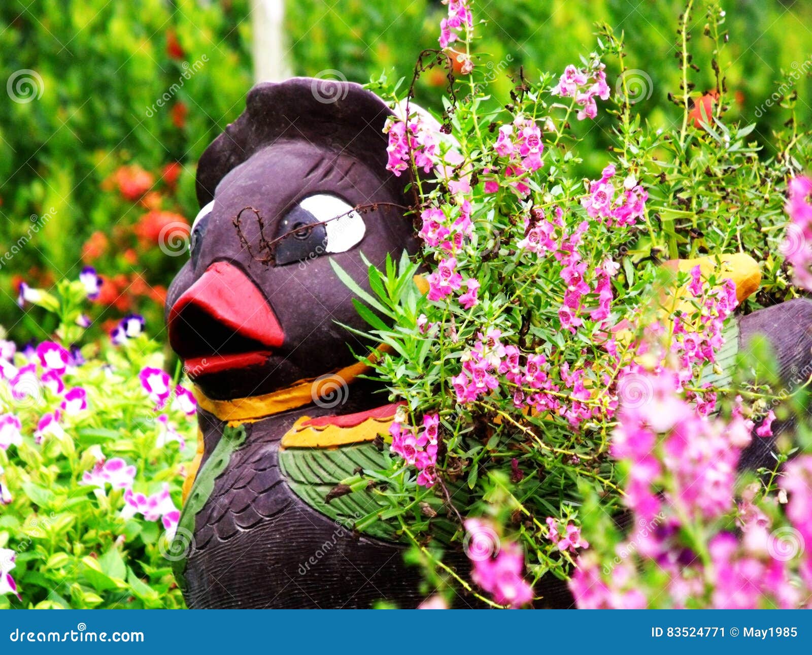 Cute Duck Statue in the Garden with Flowers Decorated Background Stock ...
