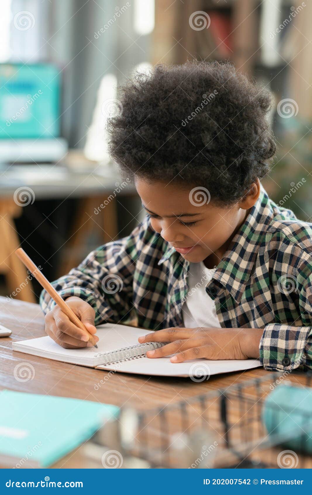 Cute Elementary Schoolboy of African Ethnicity Making Notes in Copybook ...