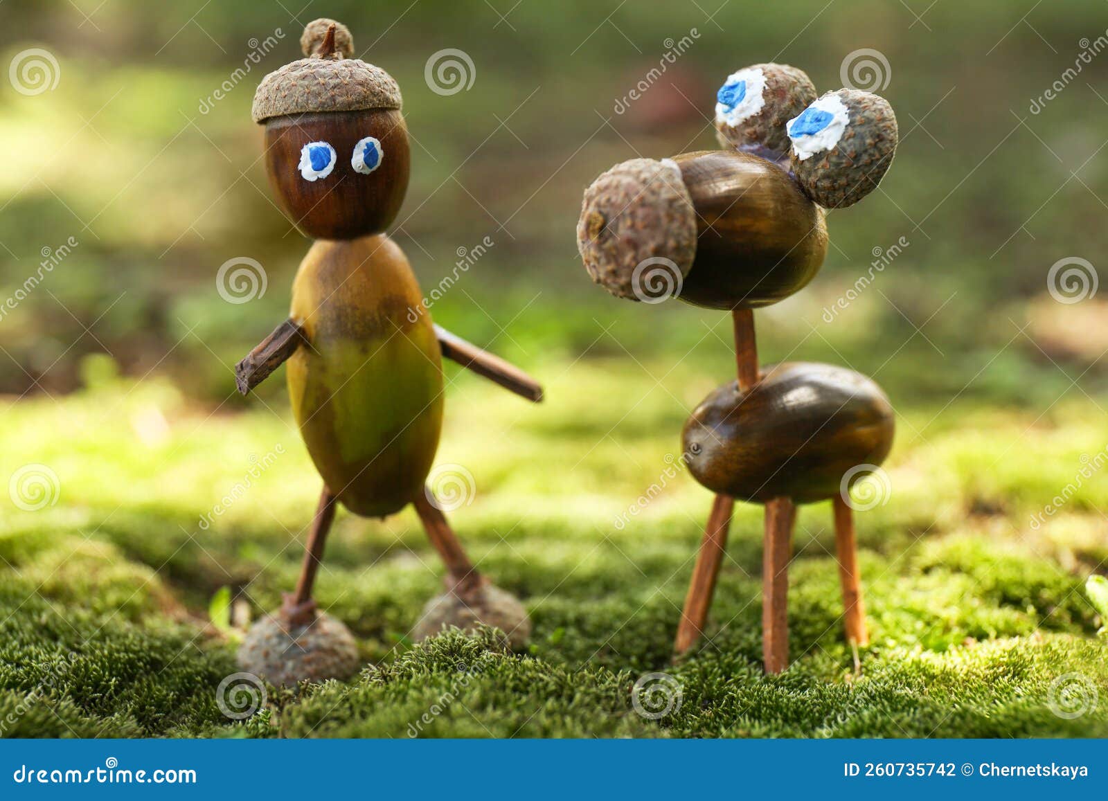 Cute Figures Made of Acorns on Green Moss Outdoors, Closeup Stock Photo ...