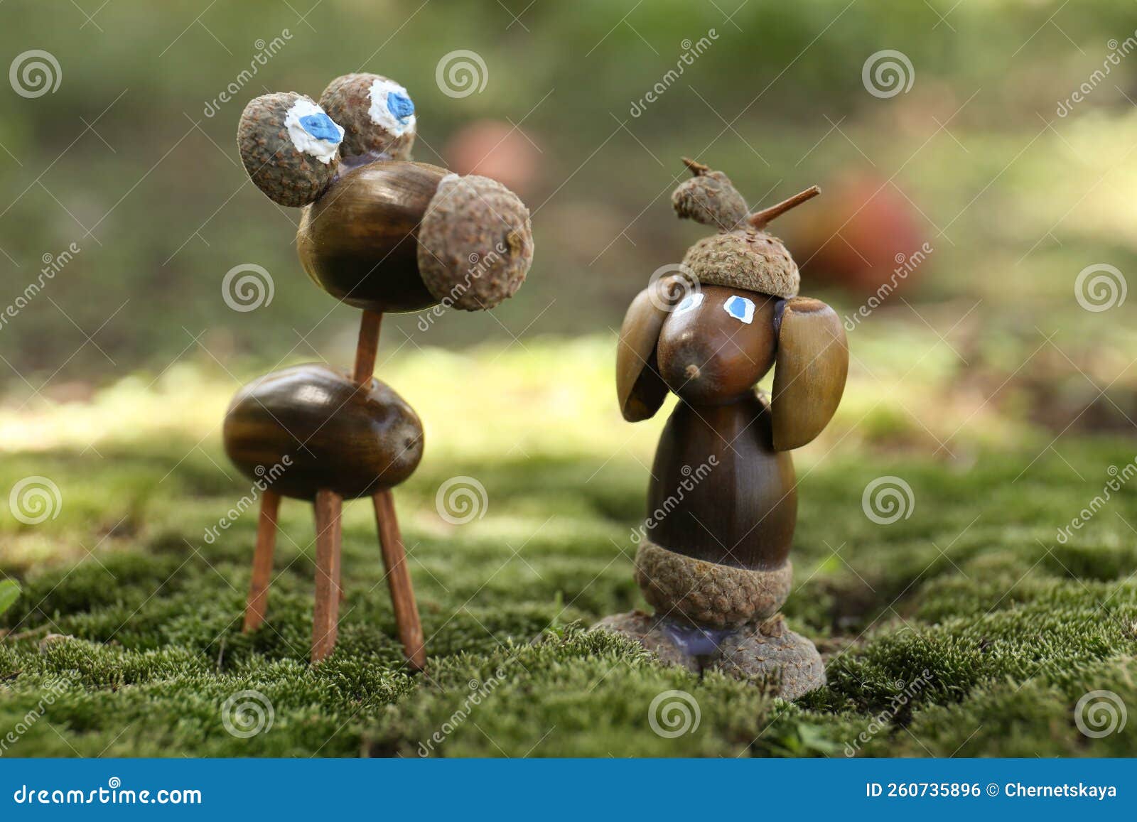 Cute Figures Made of Acorns on Green Moss Outdoors, Closeup Stock Photo ...