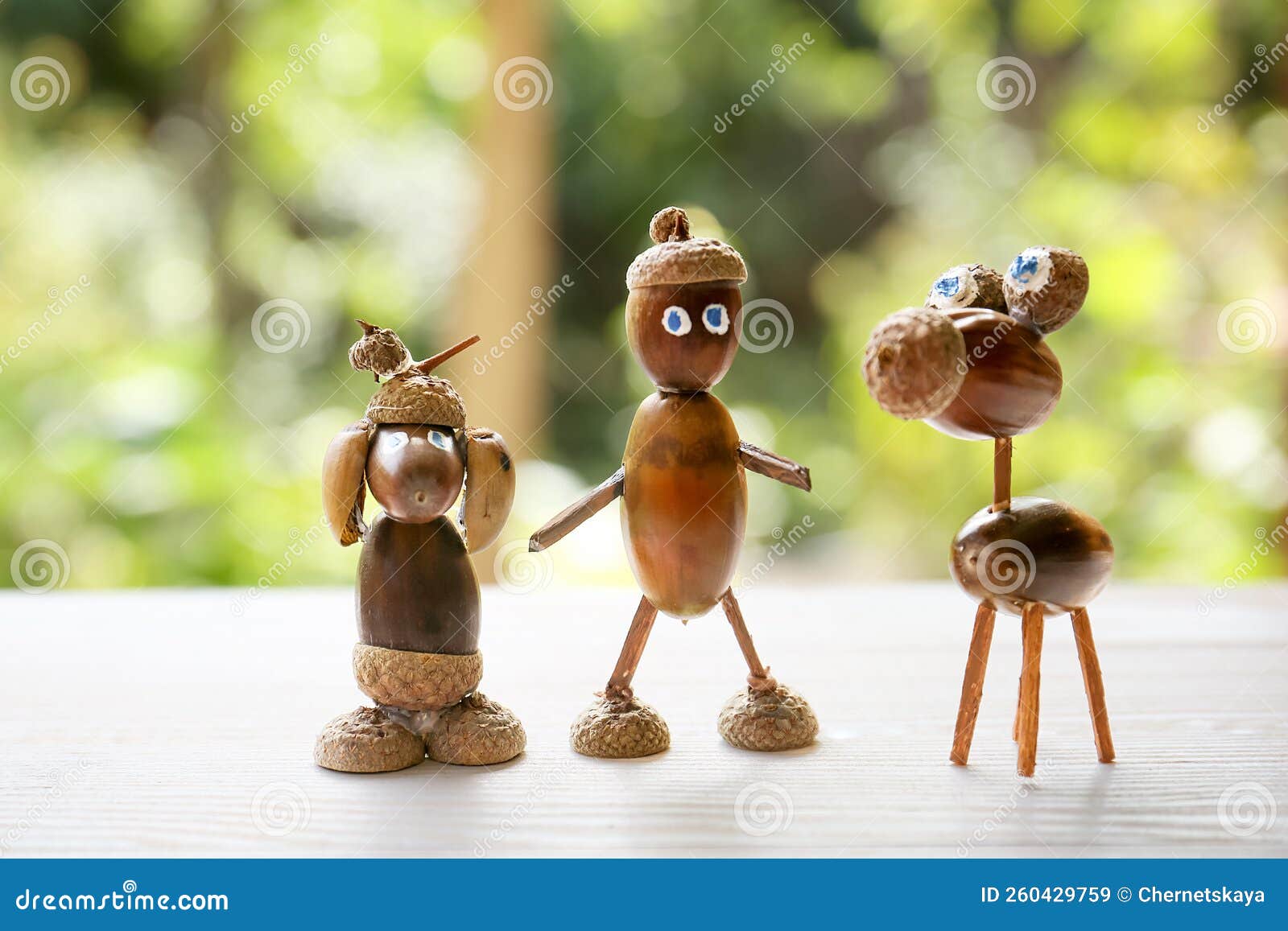 Cute Figures Made of Acorns on White Wooden Table Stock Image - Image ...