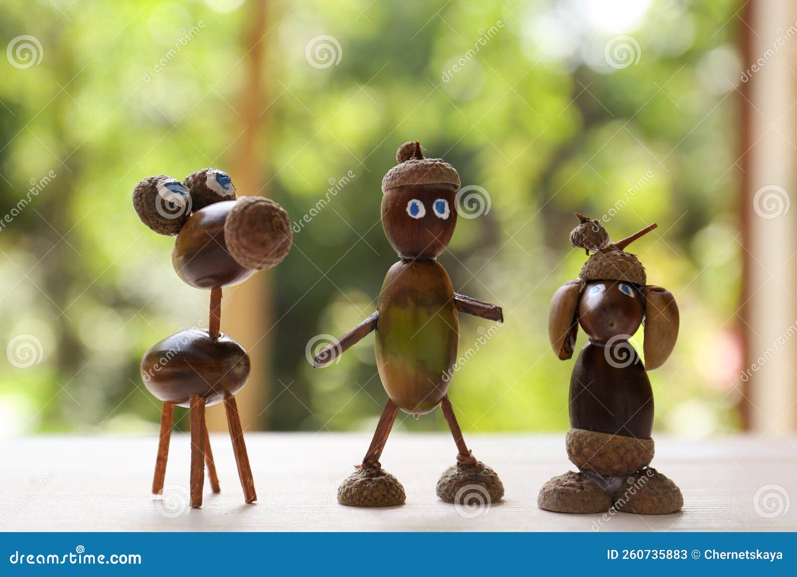 Cute Figures Made of Acorns on White Wooden Table Stock Image - Image ...