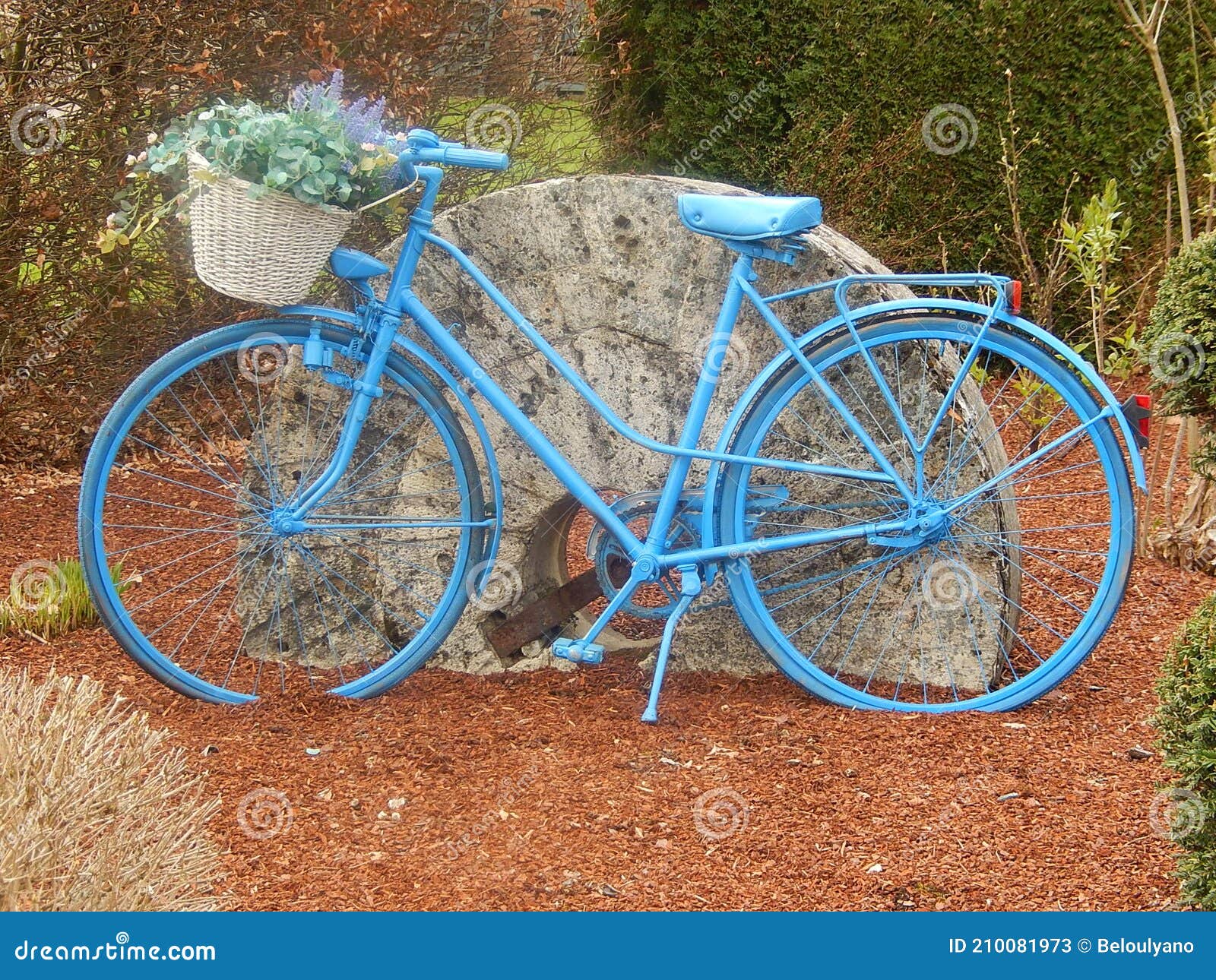 Bicycle Painted in Blue Next To the Millstone Stock Image - Image of ...