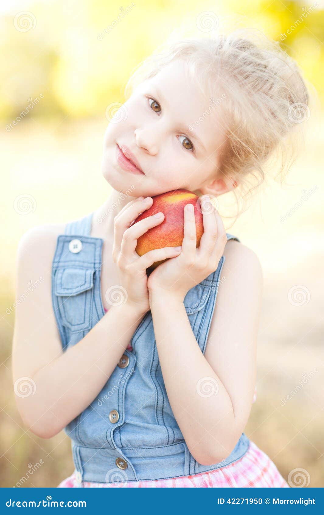 Cute girl with apple stock photo. Image of blonde, open - 42271950
