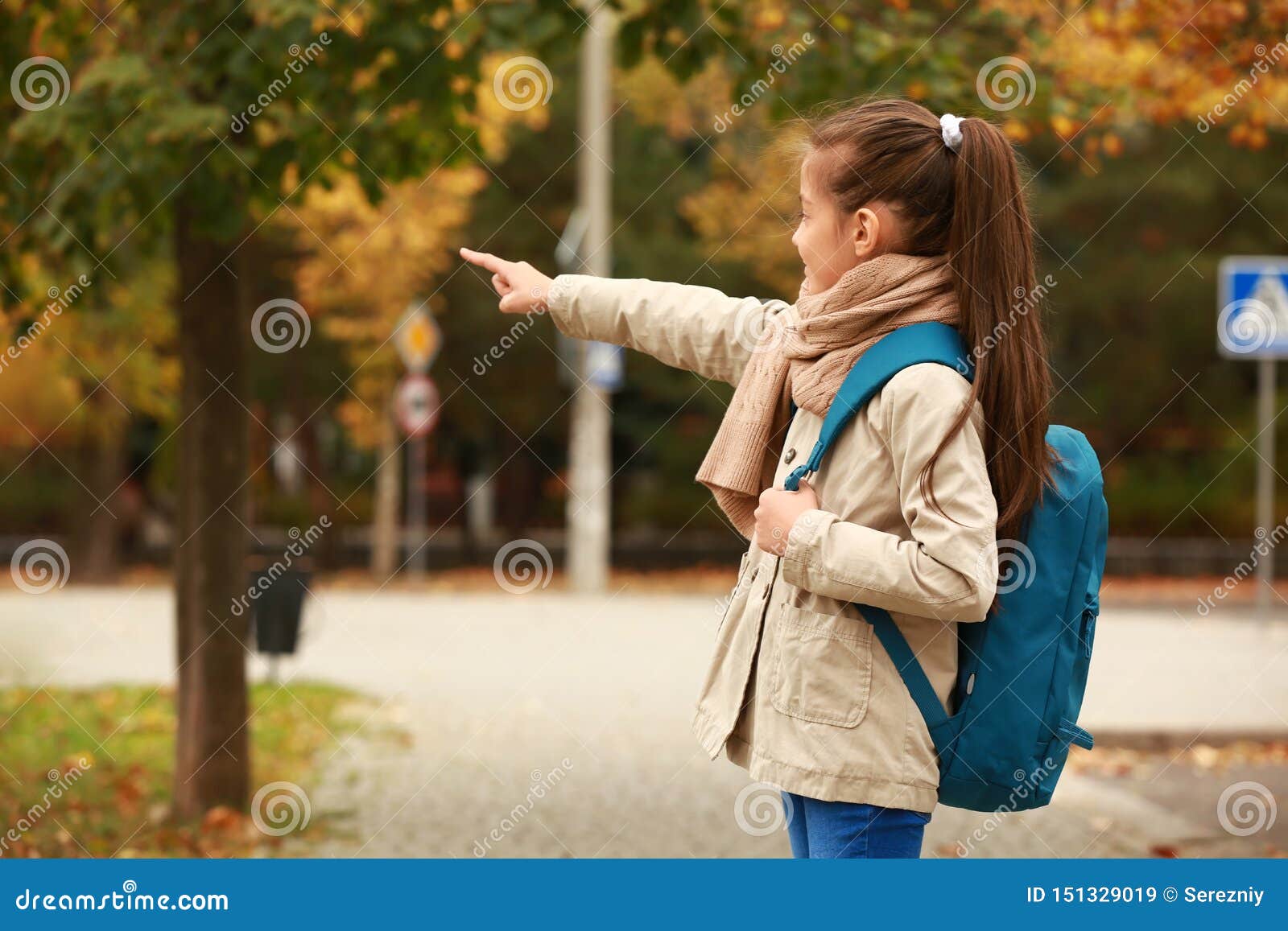 Cute Girl with Backpack Pointing at Something Outdoors Stock Image ...