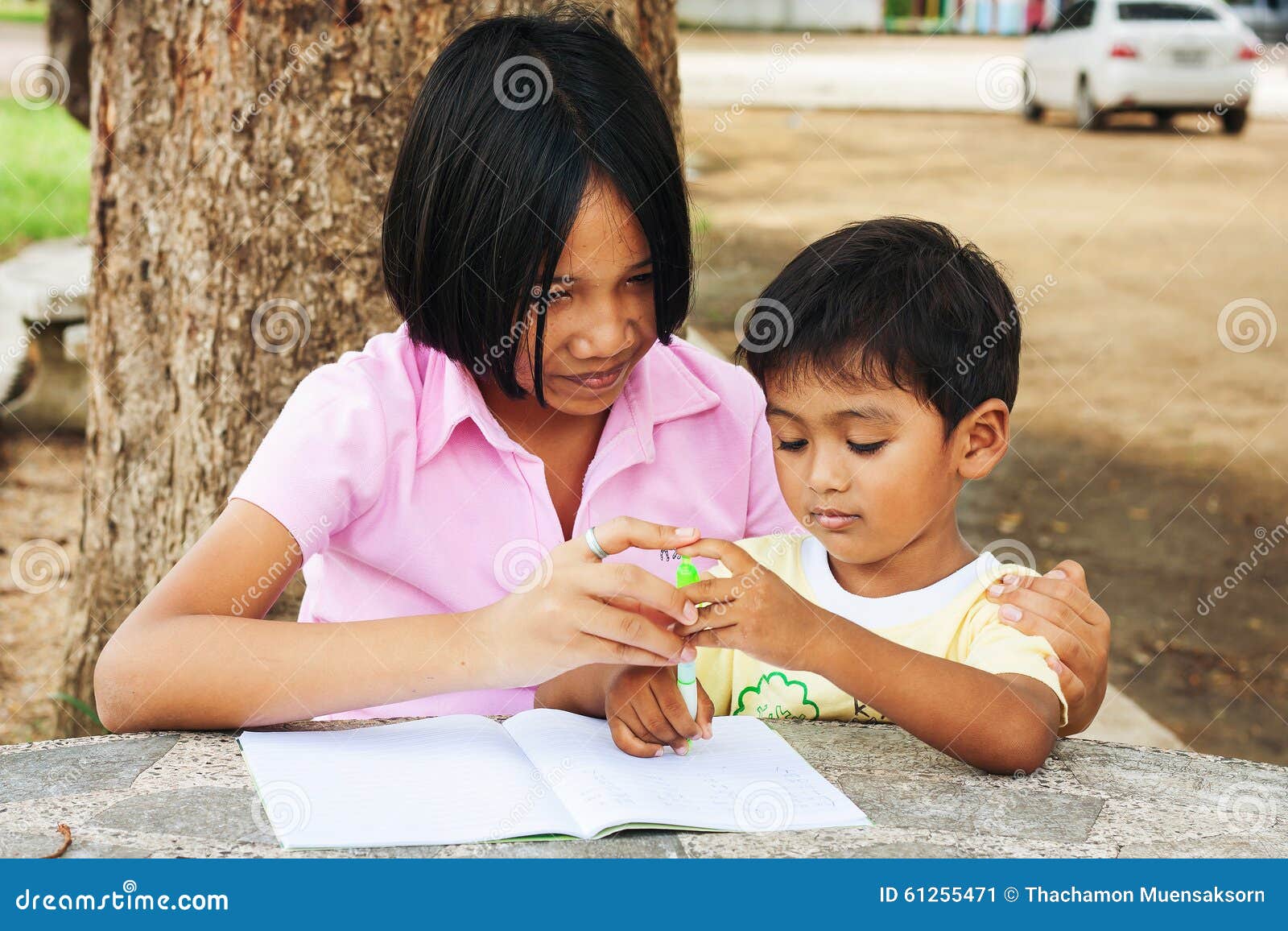 Cute Girl and Boy Writing on Book Stock Image - Image of people, girl ...