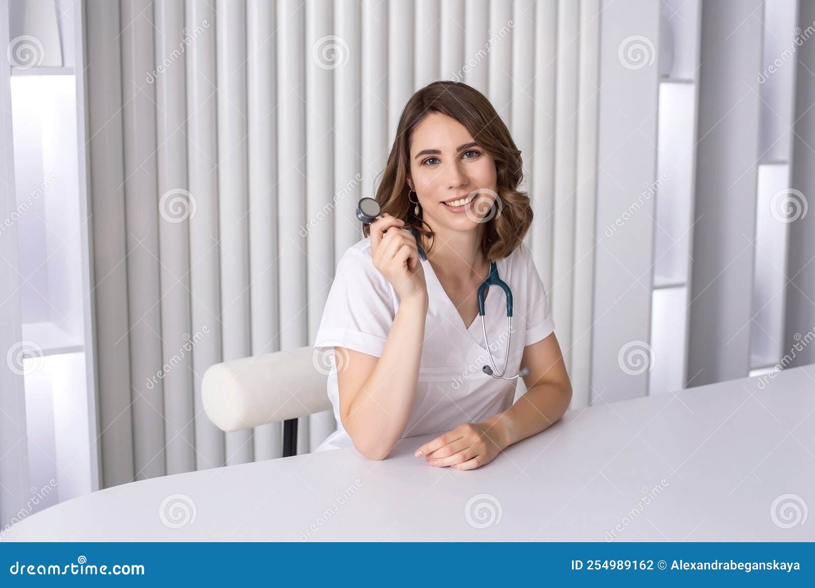 Cute Girl Doctor Sitting at a Table with a Stethoscope Stock Photo ...