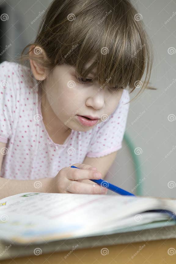Cute girl doing homework stock photo. Image of serious - 10177562