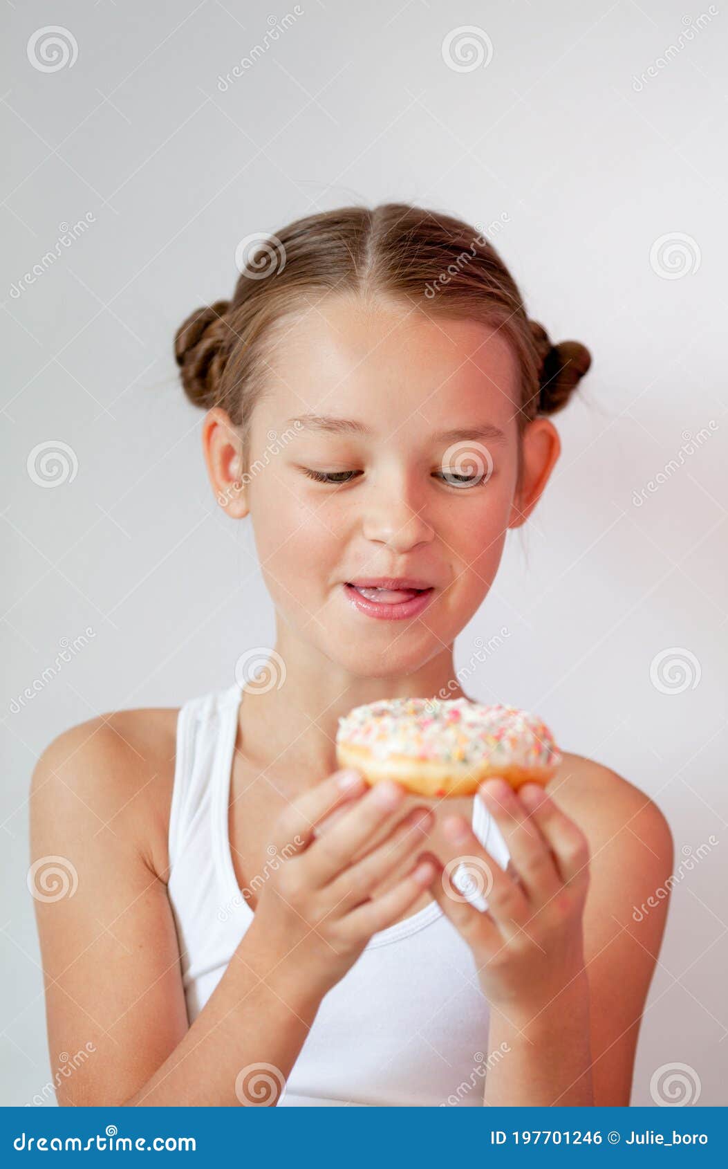 Cute Girl Holding an Appetizing Glazed Donut in Her Hands Stock Photo ...