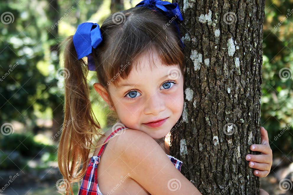 Cute girl hugging tree stock photo. Image of closeup - 21832606