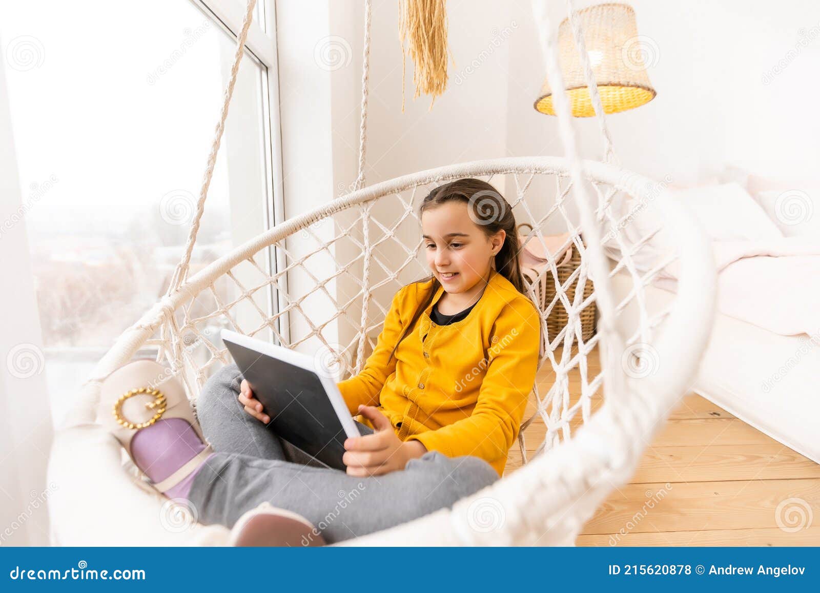 Cute Girl Lying on Sofa with Tablet Computer Stock Photo - Image of ...