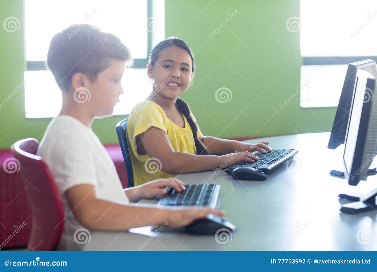 Cute Girl with Male Classmate Using Computer Stock Photo - Image of ...