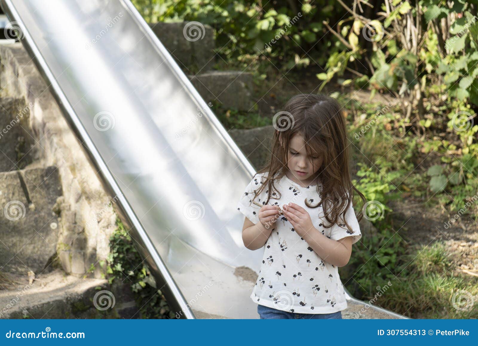 Cute Girl Playing on a Slide in the Park. Selective Focus Stock Image ...