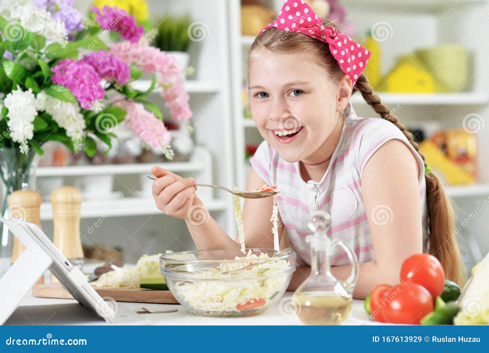 Cute Girl Preparing Delicious Fresh Salad In Kitchen Stock Image