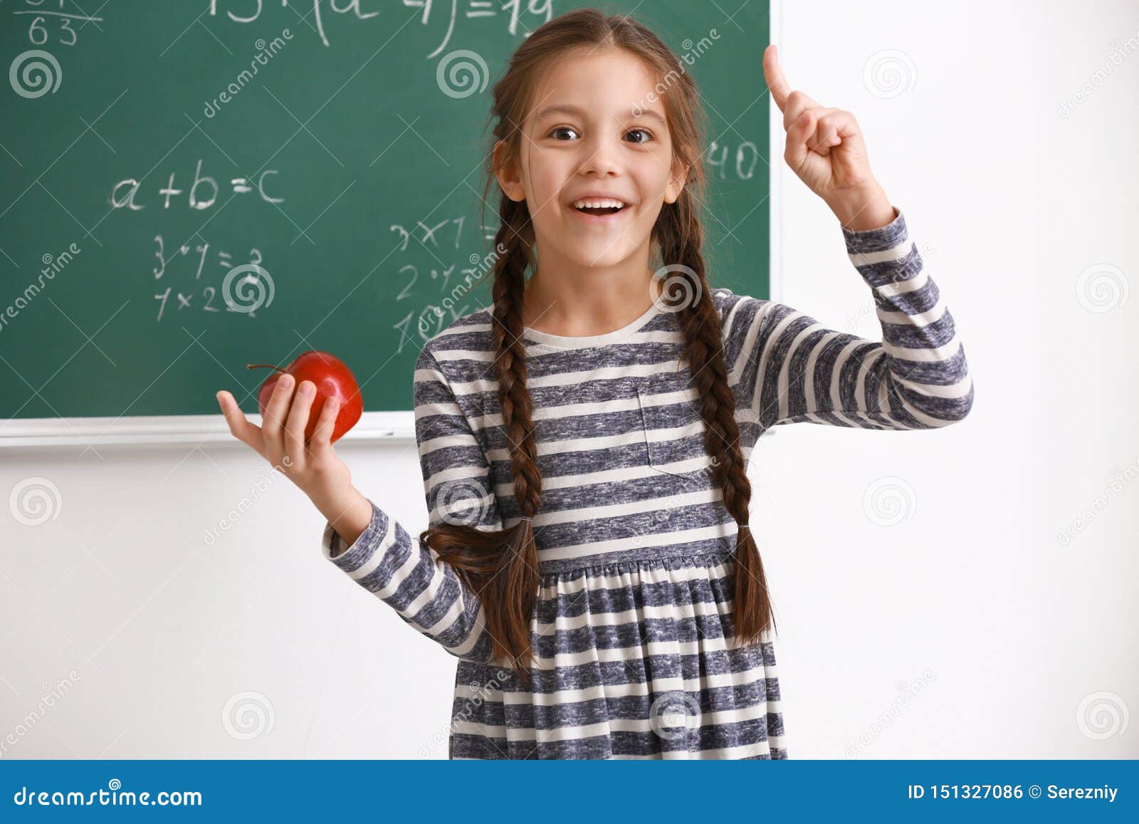 Cute Girl with Raised Index Finger in Classroom Stock Photo - Image of ...