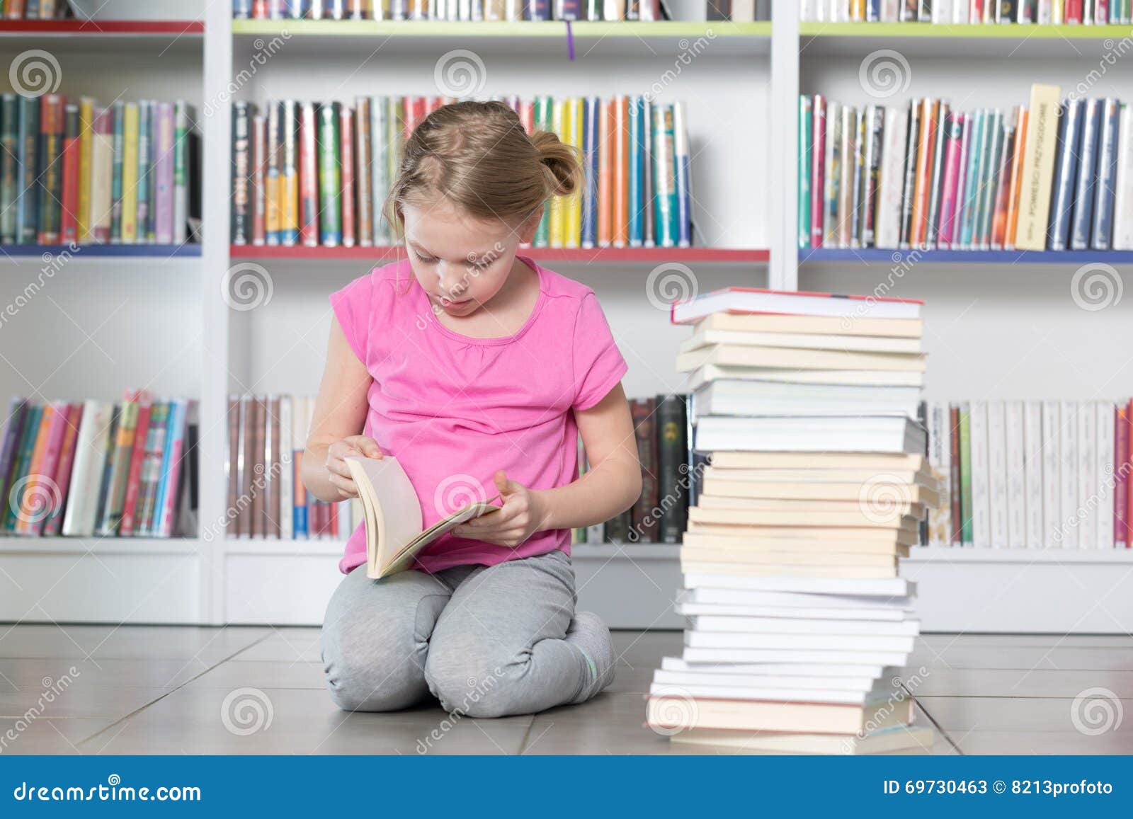 Cute Girl Reading Book in Library Stock Image - Image of caucasian ...